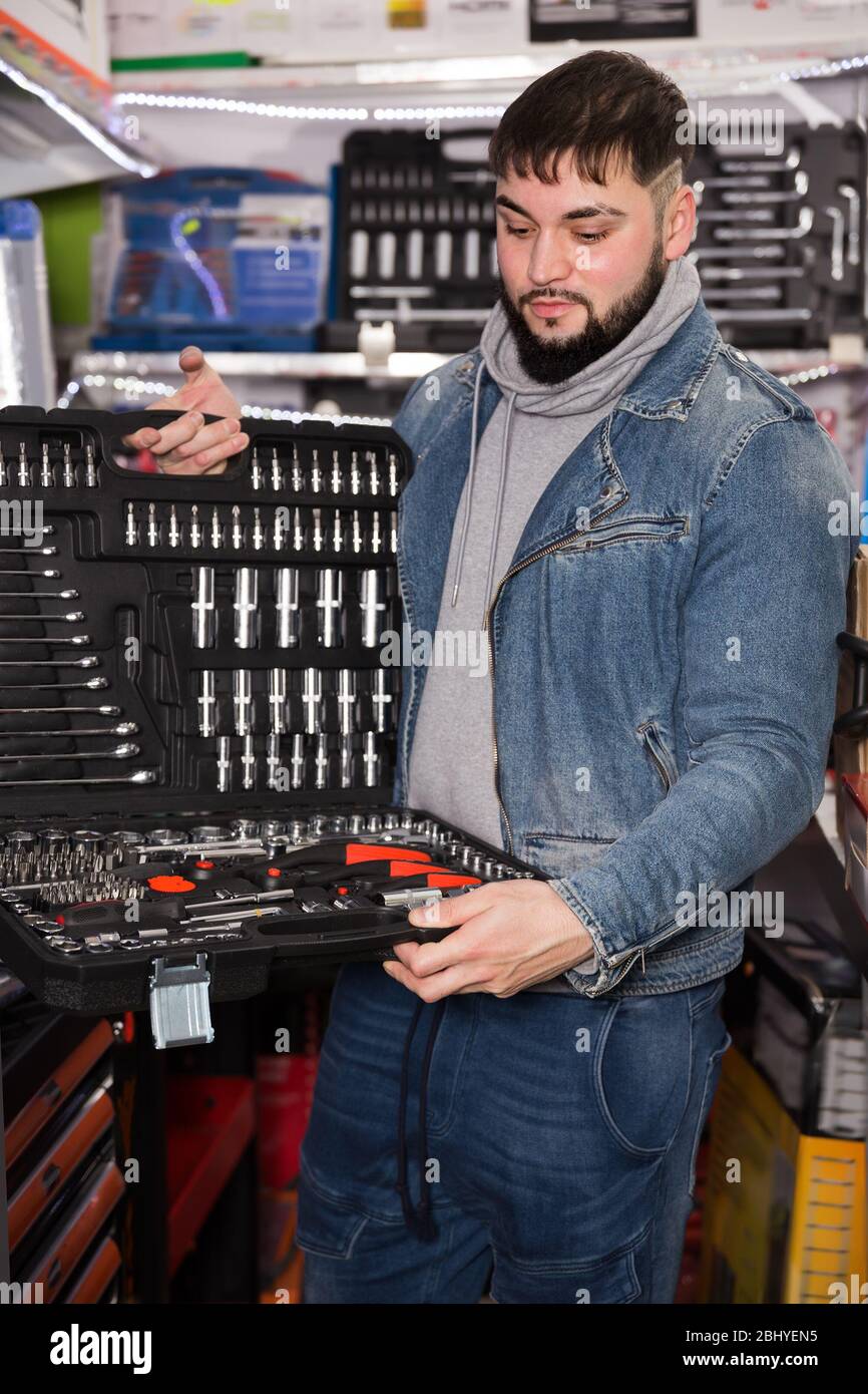 Nice man is choosing ratchet in tools store Stock Photo - Alamy
