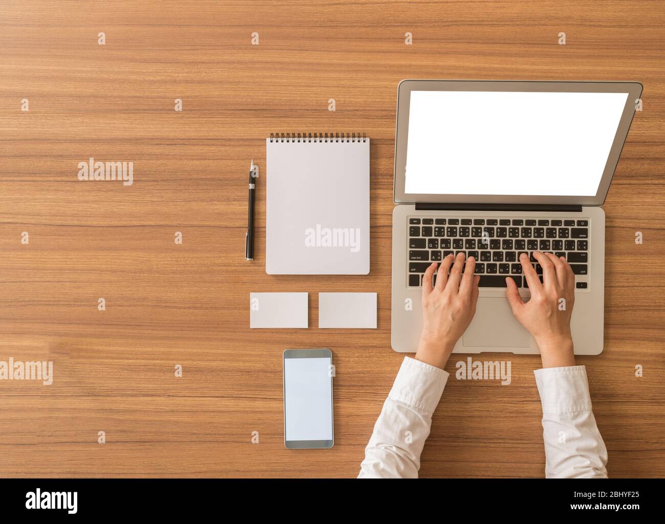 Human typing labtop computer with electronic devices on office desk ...