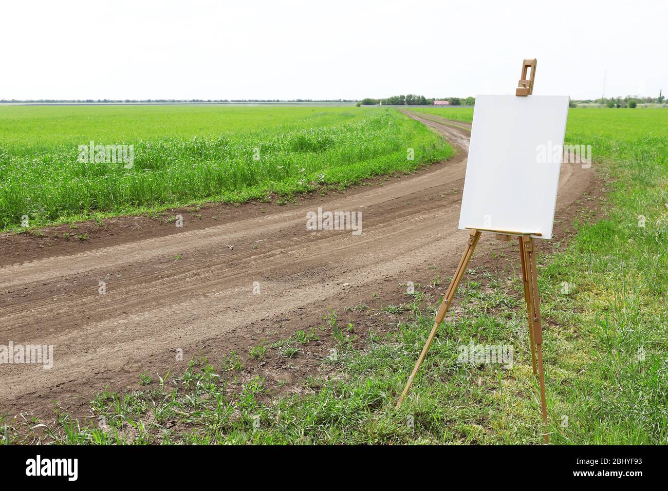 Easel with canvas near country road Stock Photo - Alamy