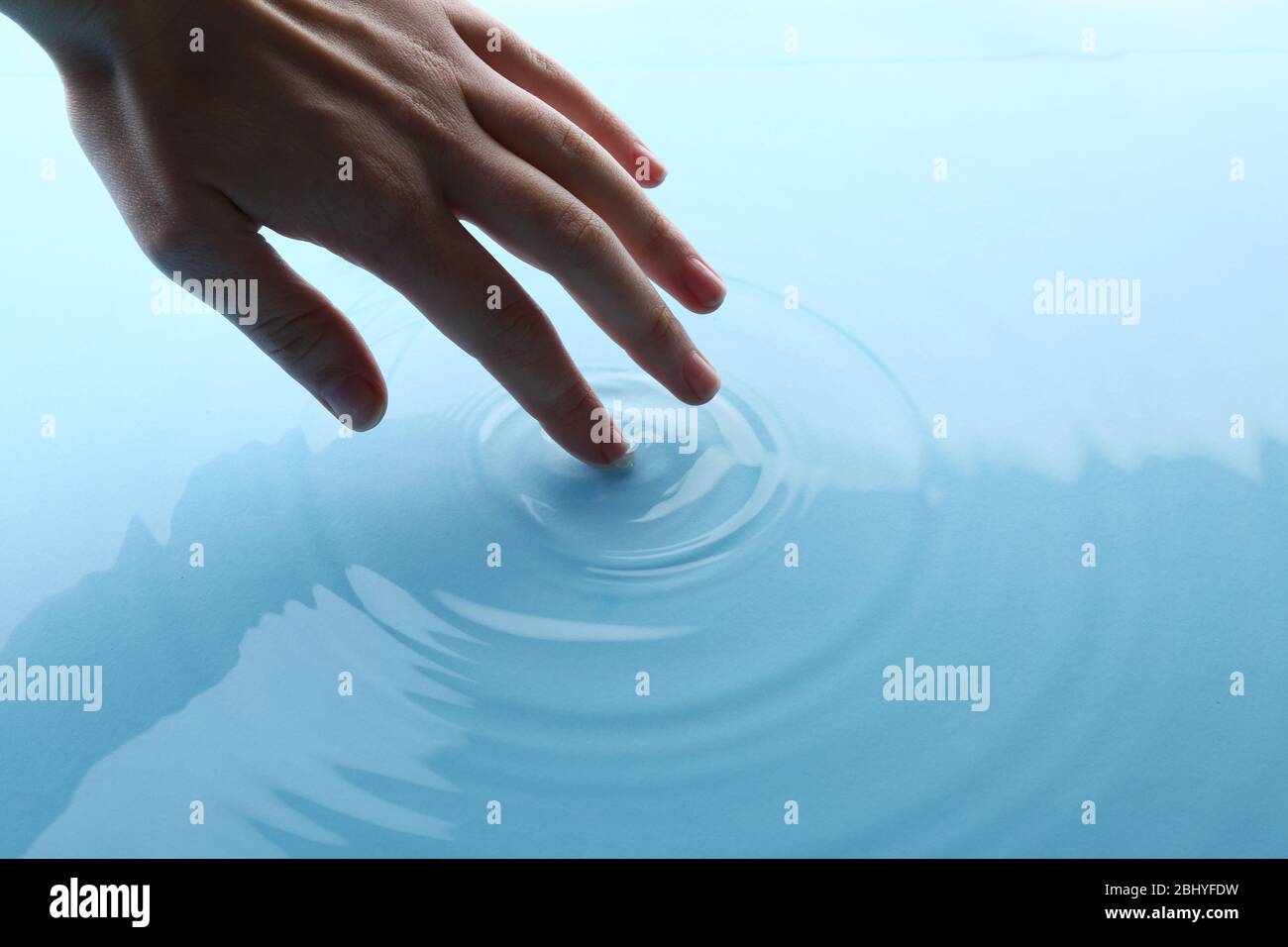 Finger touches water close up Stock Photo - Alamy