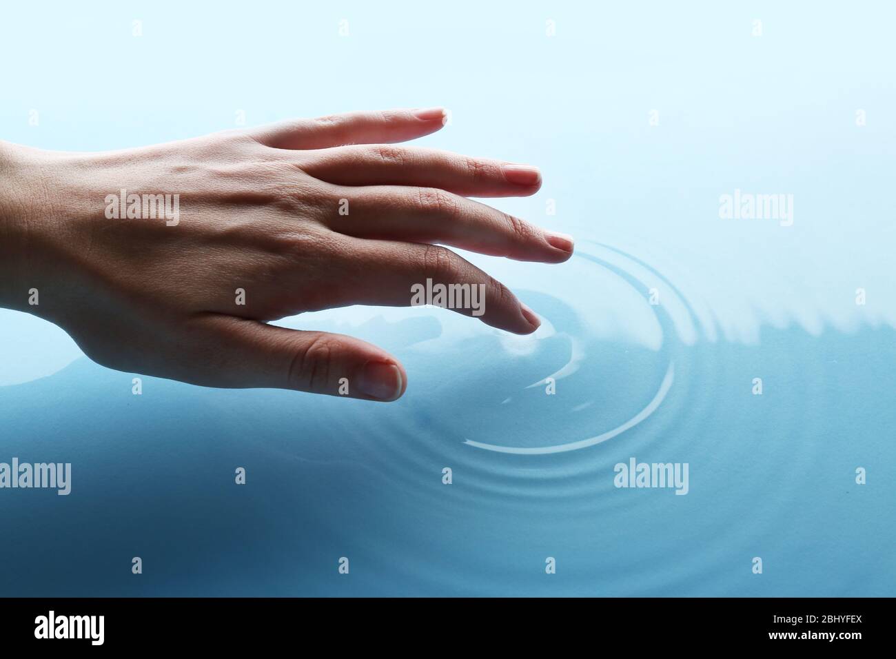 Finger touches water close up Stock Photo - Alamy