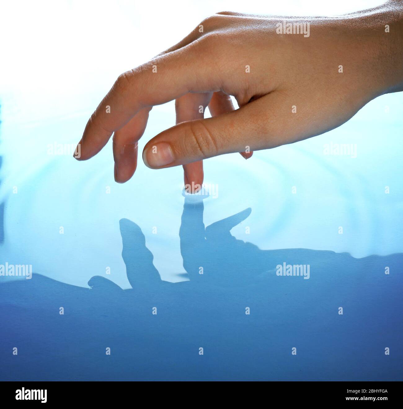 Finger touches water close up Stock Photo - Alamy
