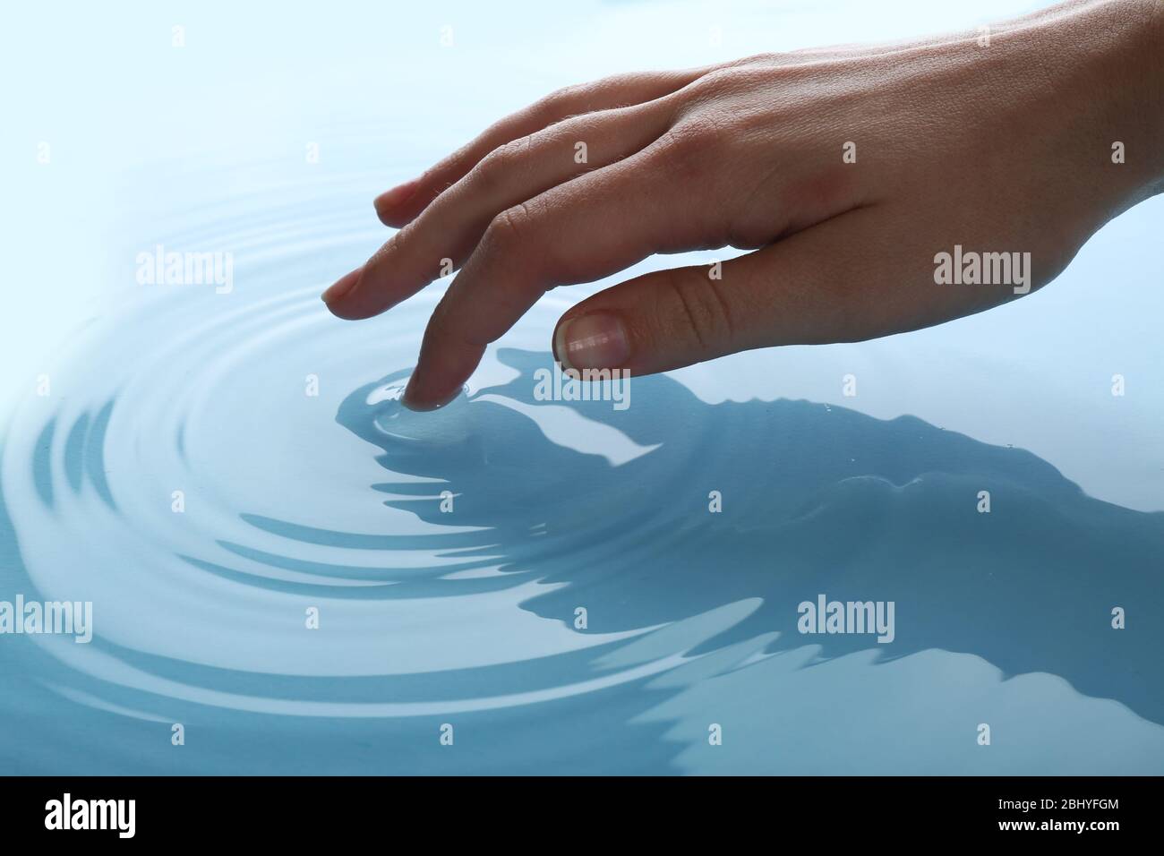 Finger touches water close up Stock Photo - Alamy