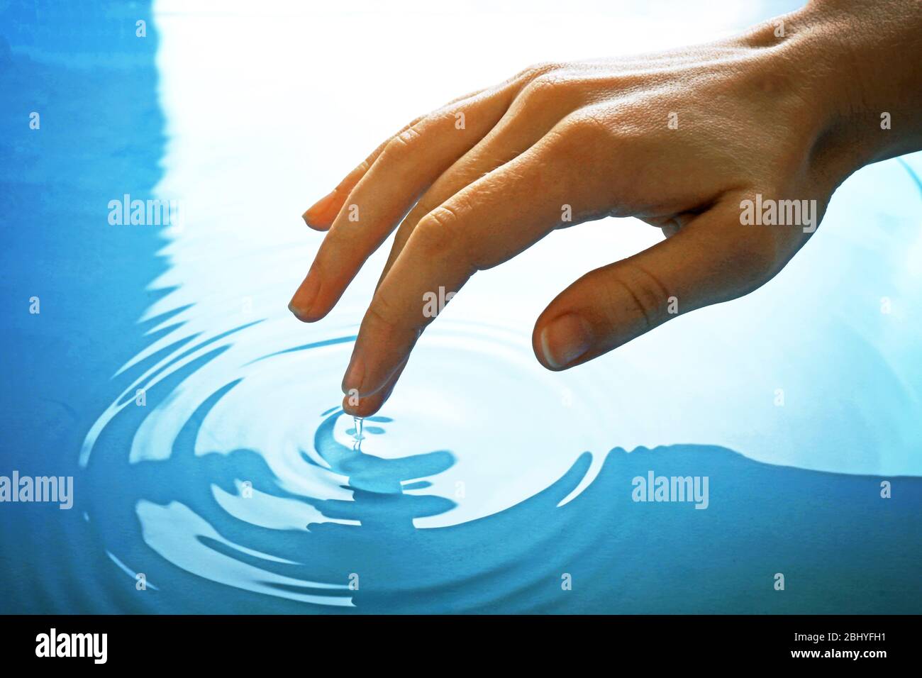 Finger touches water close up Stock Photo - Alamy