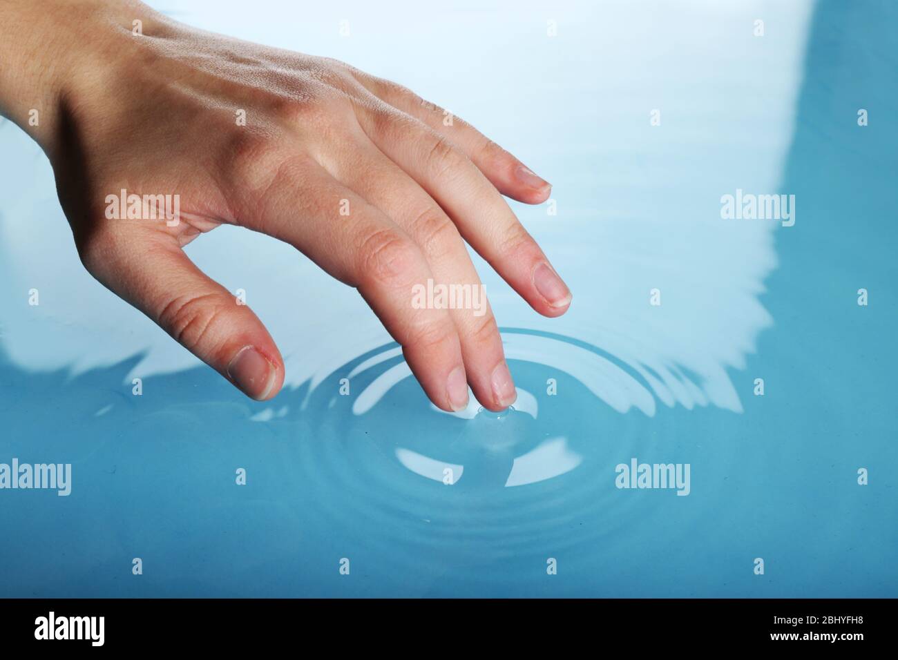 Finger touches water close up Stock Photo - Alamy
