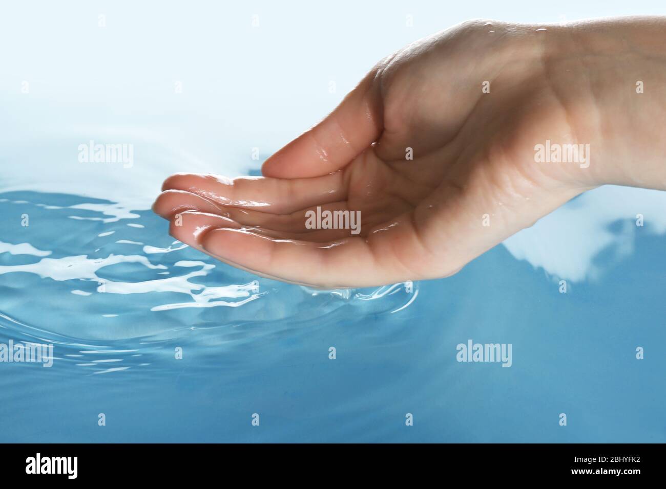 Finger touches water close up Stock Photo - Alamy