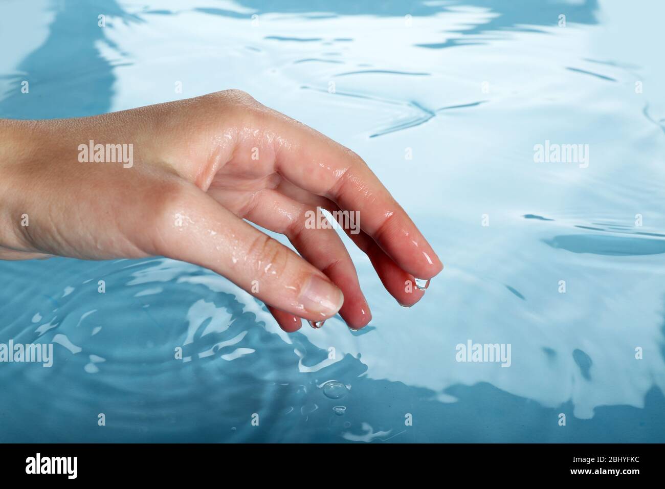 Finger touches water close up Stock Photo - Alamy