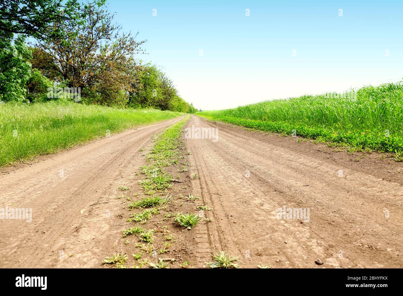 Country road over blue sky background Stock Photo - Alamy