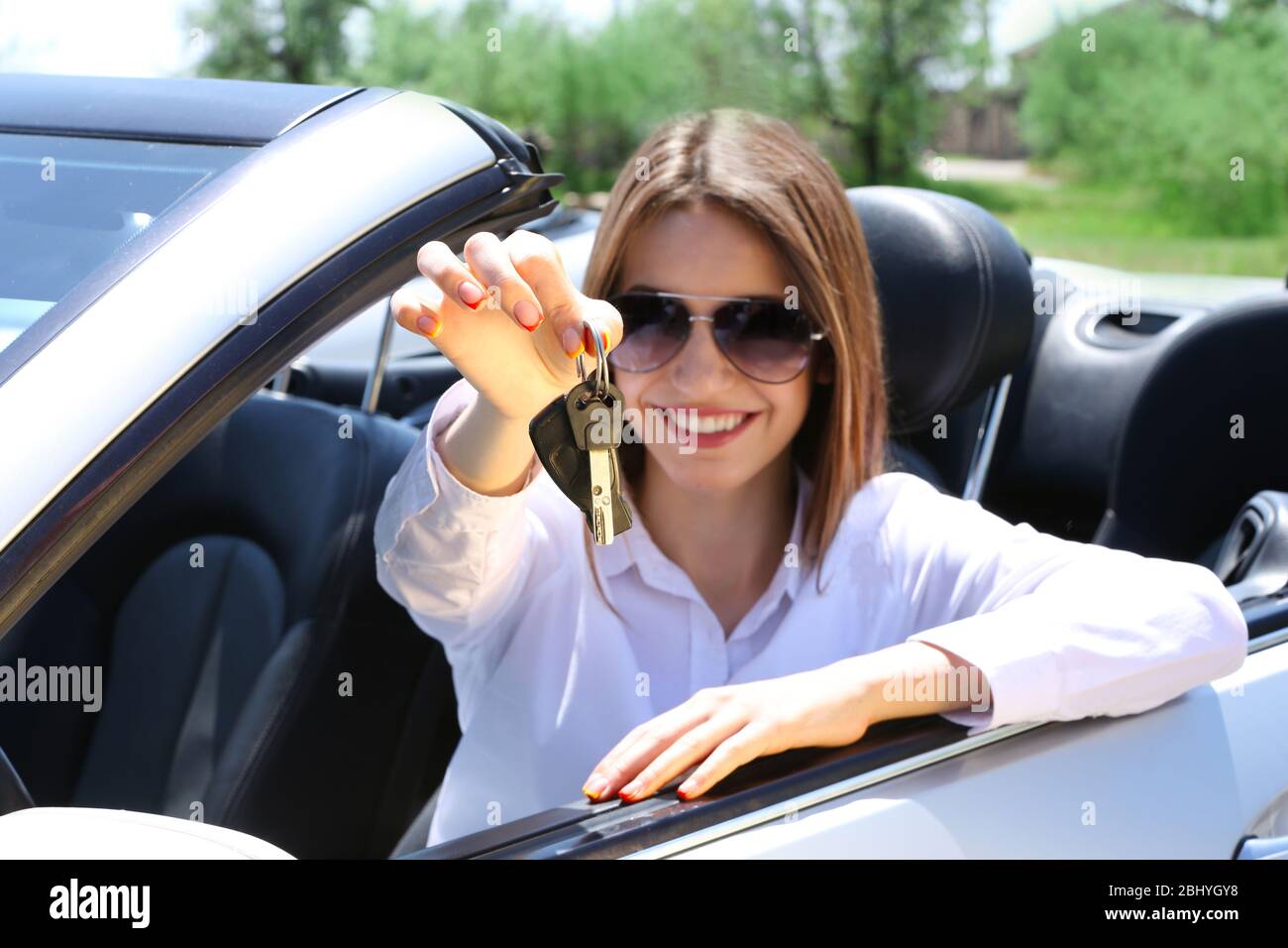 Young girl with keys in cabriolet, outdoors Stock Photo - Alamy