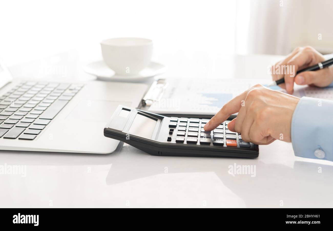Businessman using a calculator to calculate the numbers. Accounting ...