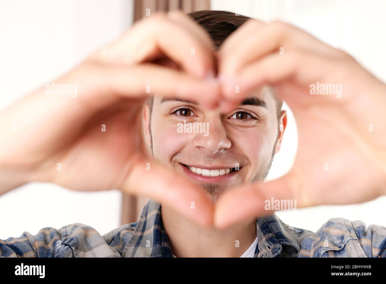Handsome young man makes heart hi-res stock photography and images - Alamy