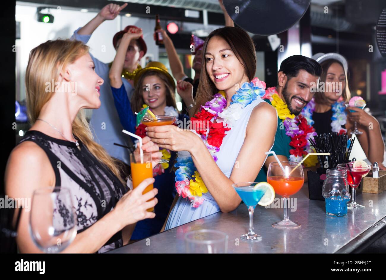 Women are drinking cocktails on hawaiian party in nightclub Stock Photo ...