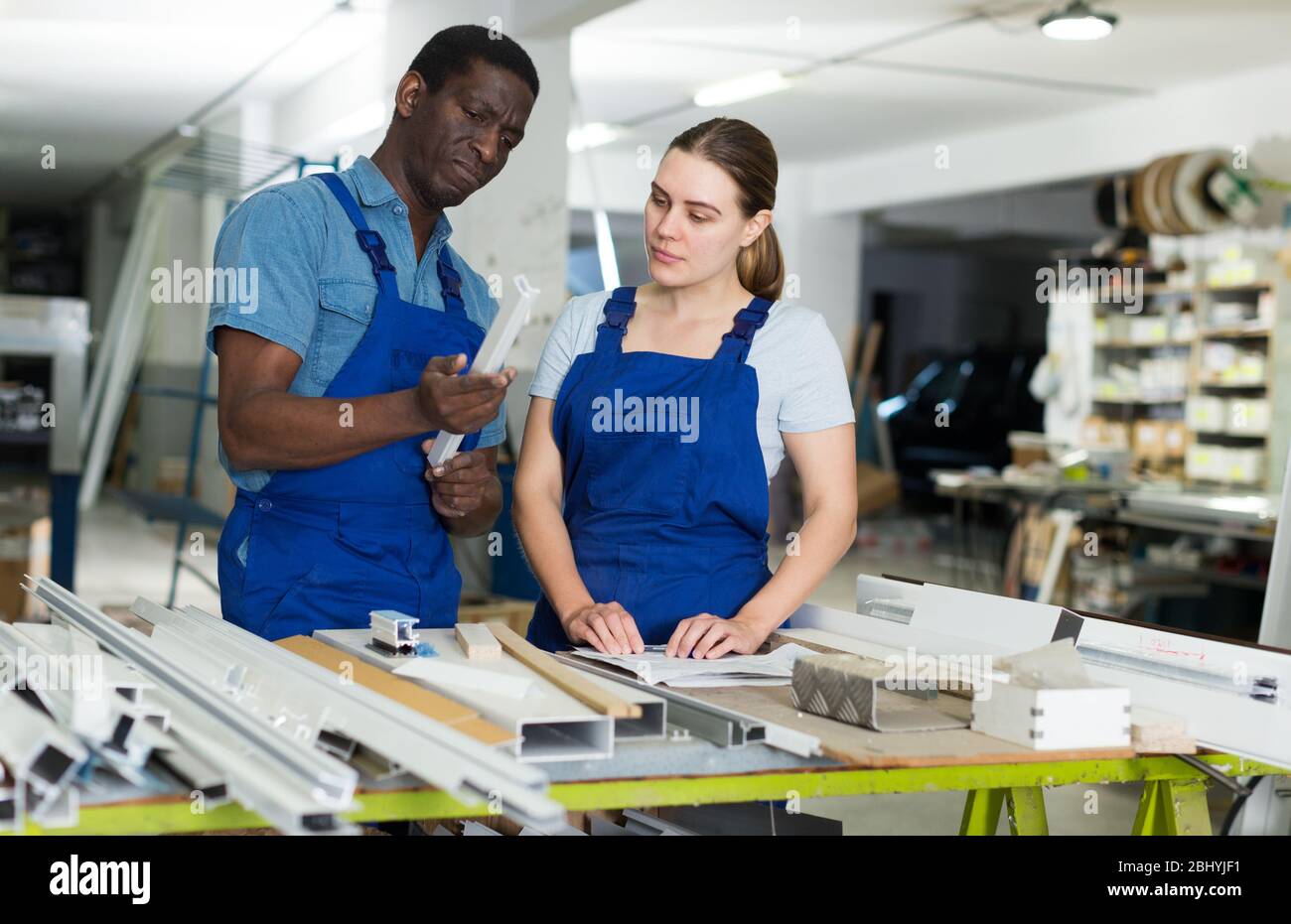 Two masters are working on their workplace in the window workshop Stock ...