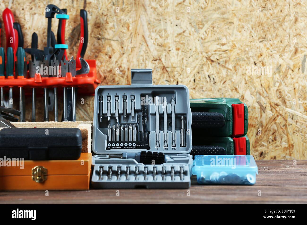 Set of tools in workshop on plywood background Stock Photo - Alamy