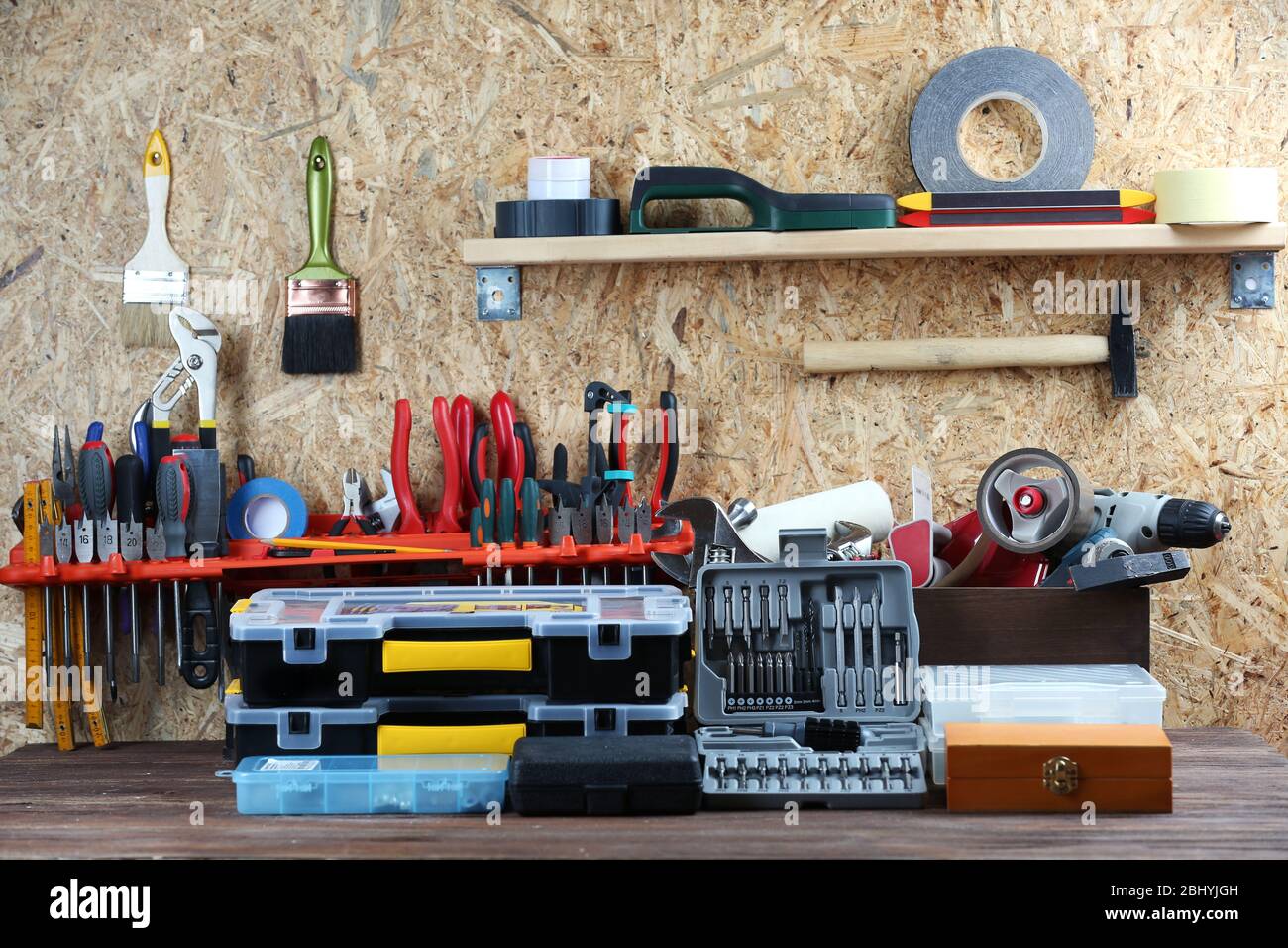 Set of tools in workshop on plywood background Stock Photo - Alamy