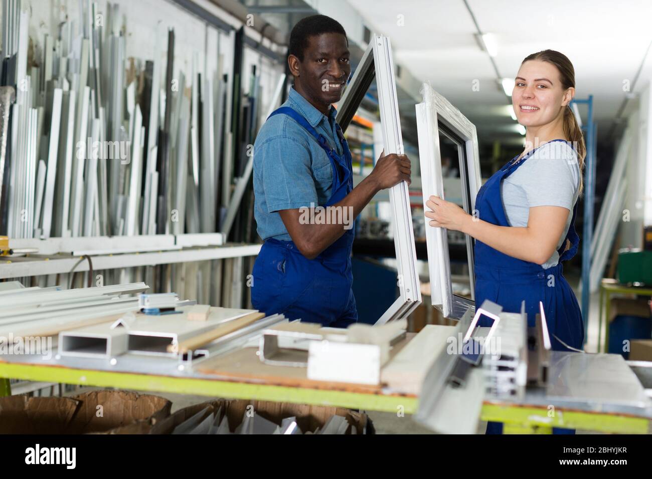 Two masters are working with window frame in the window workshop Stock ...