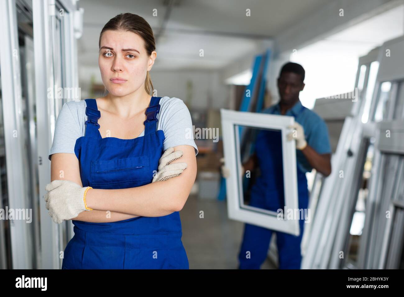 Portrait of sad woman worker who is standing in the pvc workshop Stock ...