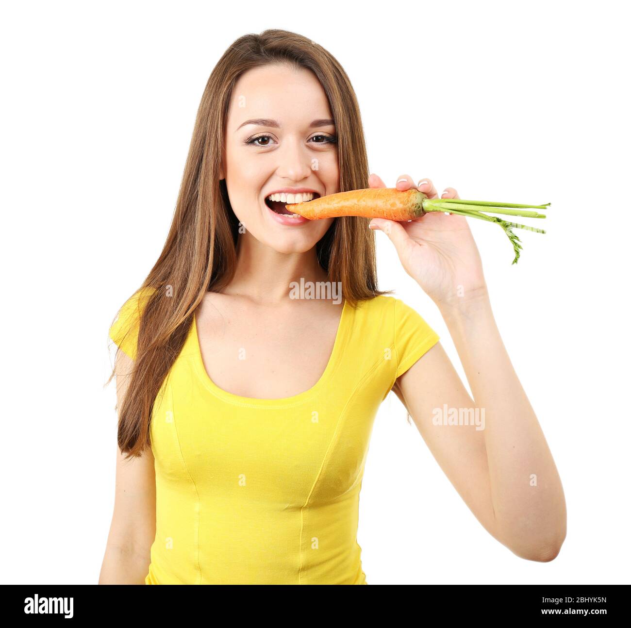 Healthy young woman eating carrot isolated on white Stock Photo - Alamy