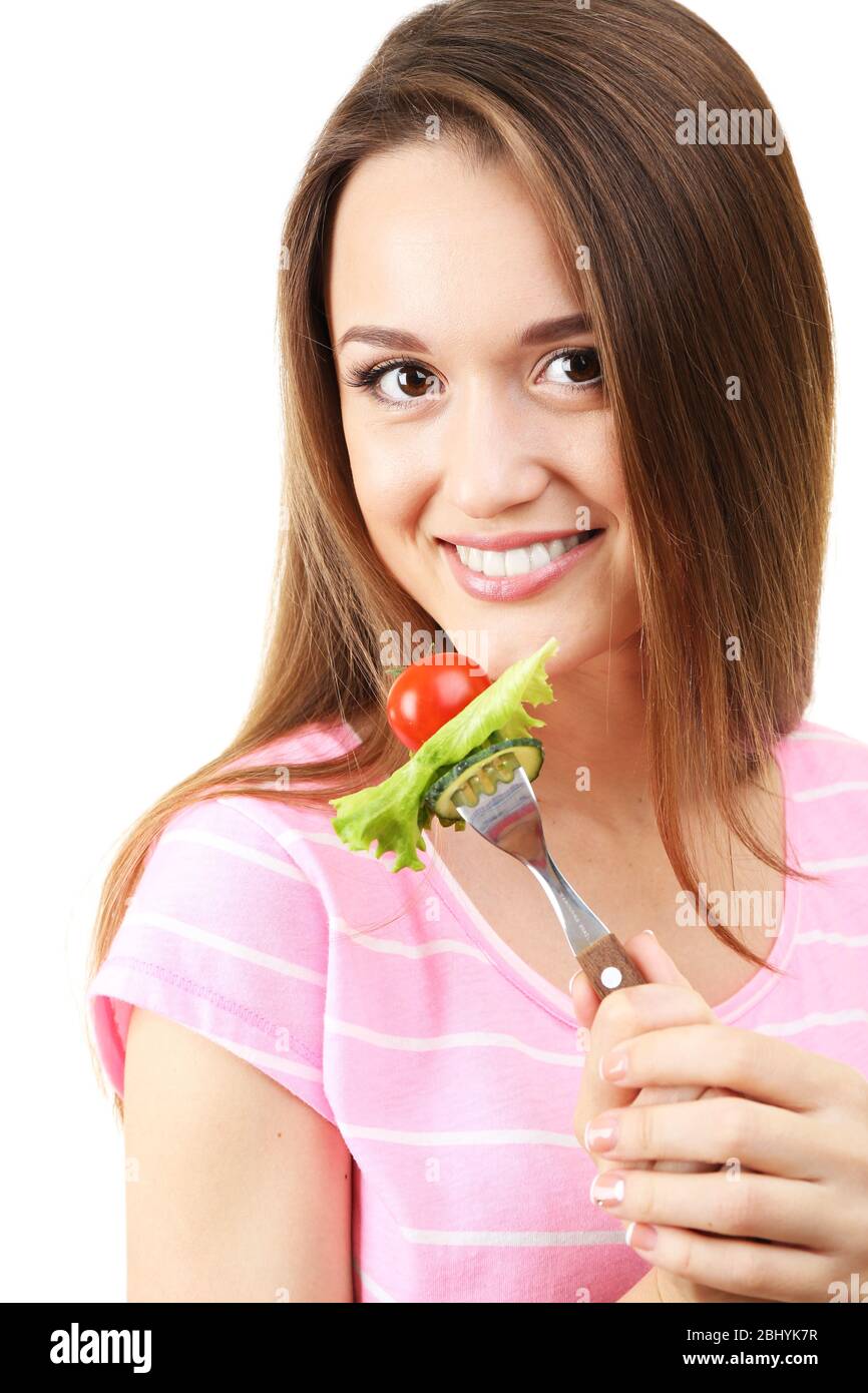 Healthy young woman with vegetables on fork isolated on white Stock ...