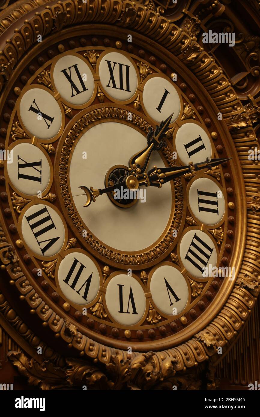 The famous clock face in the Musee d'Orsay in Paris. A gold clock face ...