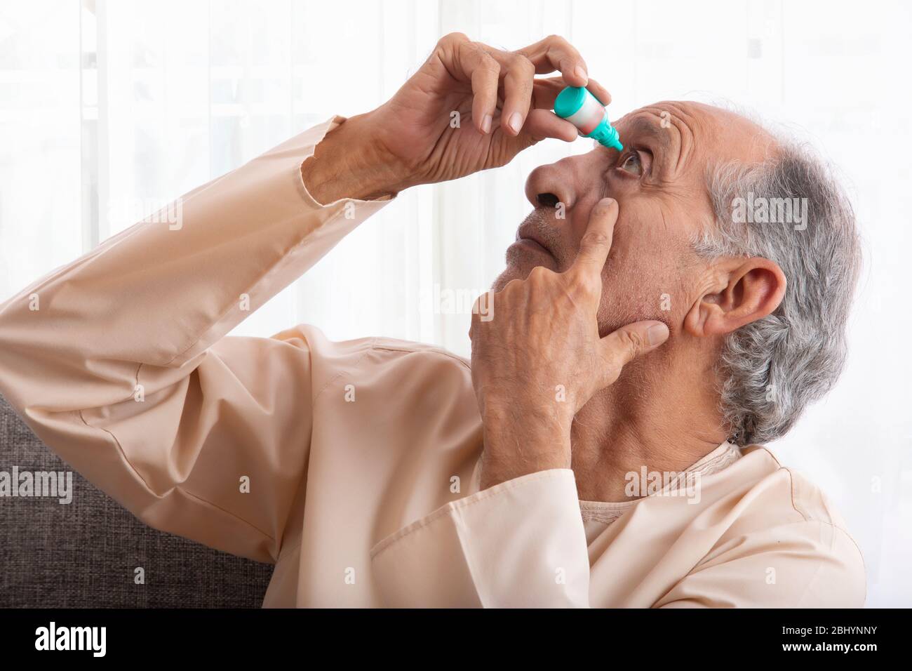 Senior man putting eye drops on his own. (Health and fitness Stock ...