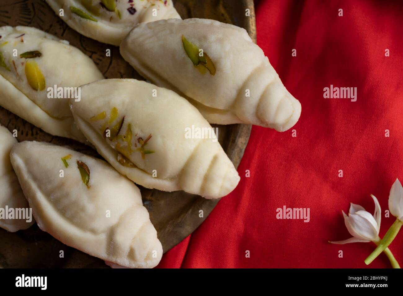 Shankh shaped sondesh kept on a plate together Stock Photo - Alamy