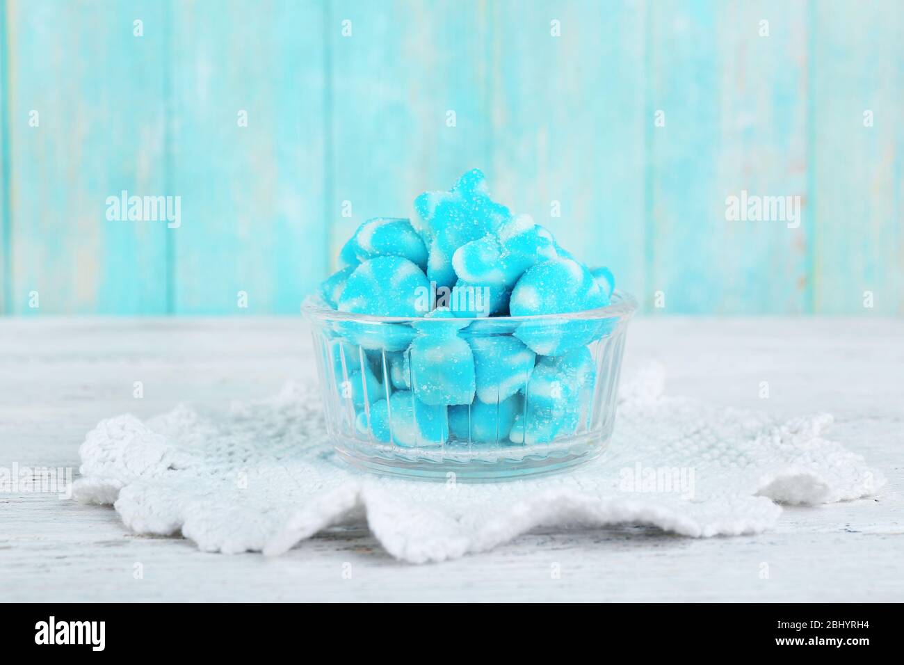 Blue candies in glass saucer on wooden background Stock Photo - Alamy