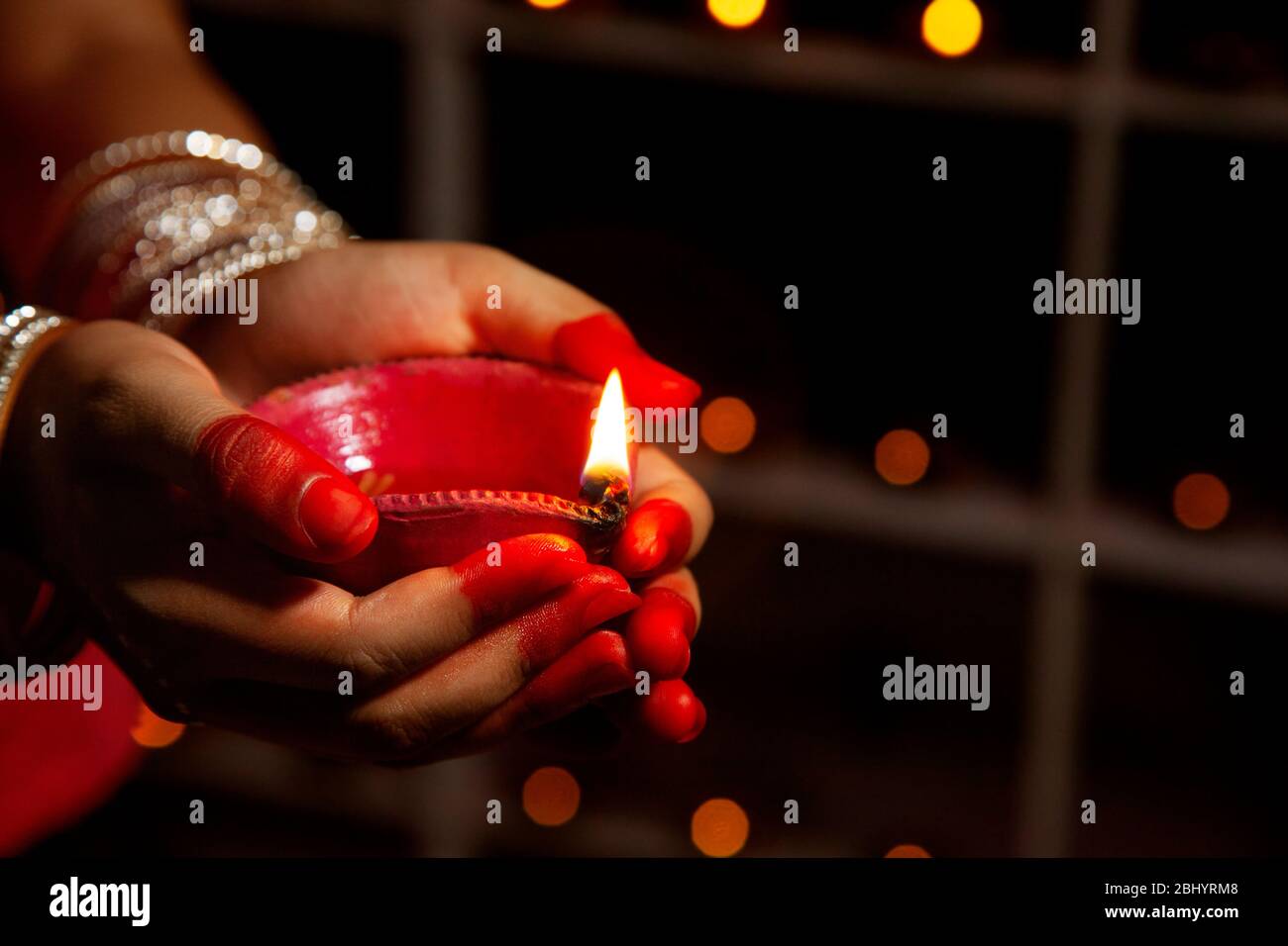 Diya in hands hi-res stock photography and images - Alamy
