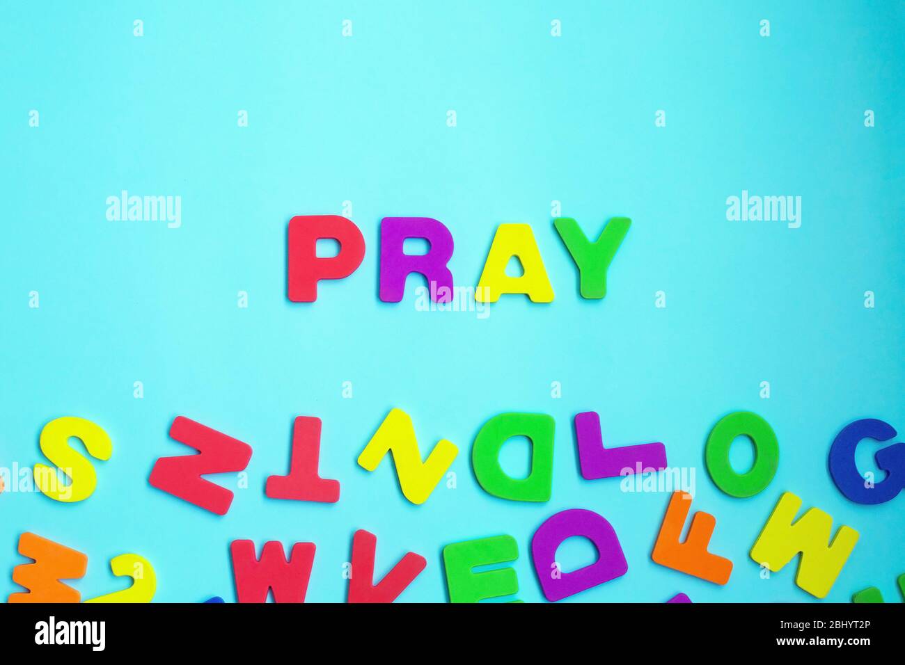 Word PRAY made of colorful letters on blue background. CHRISTIANITY ...