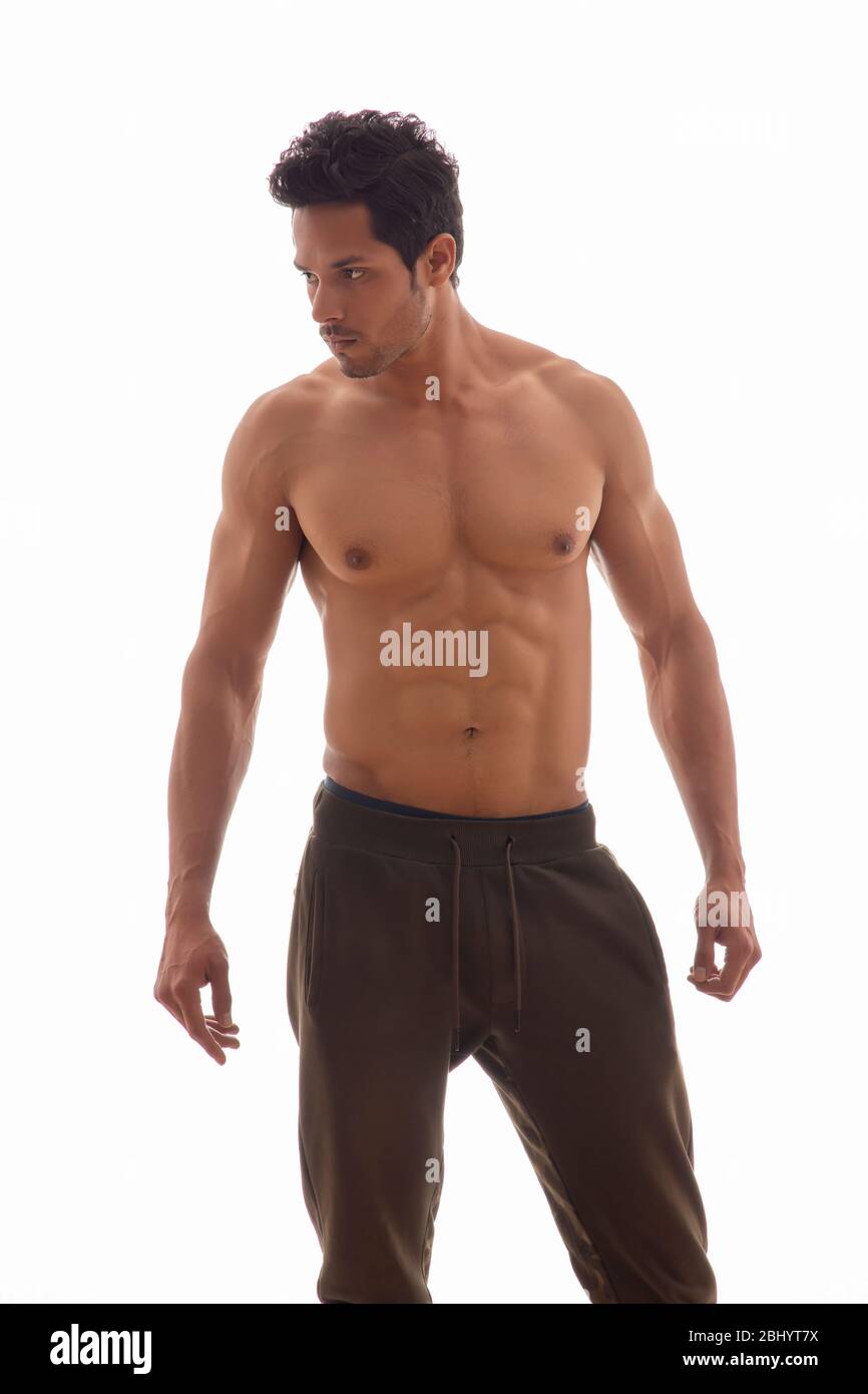 Man flexing his muscles in front of a white background Stock Photo - Alamy