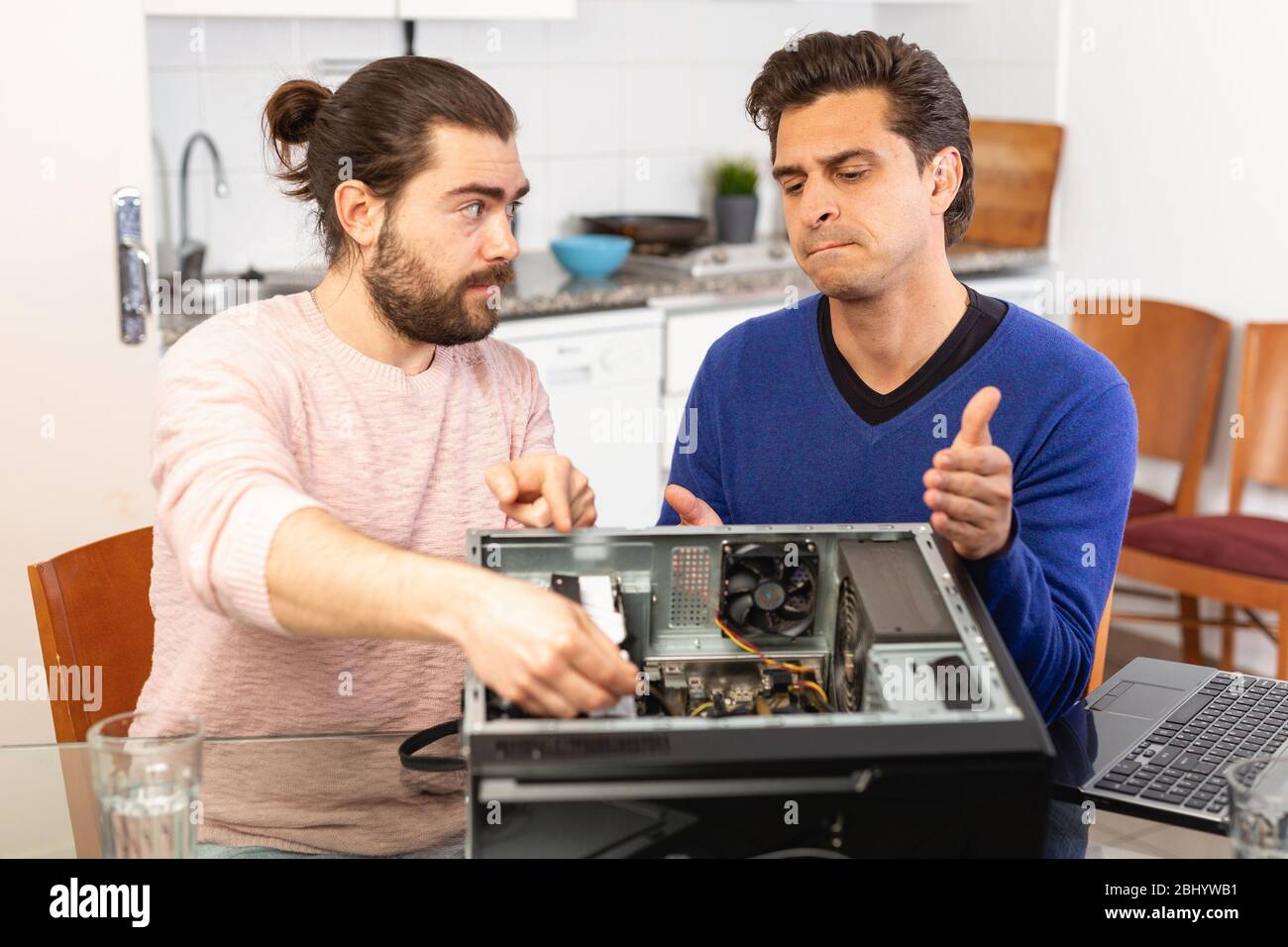 Two men repairing a desktop computer Stock Photo - Alamy