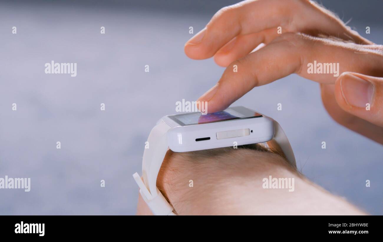 Man using wearable smartwatch computer device in the room - scrolling ...