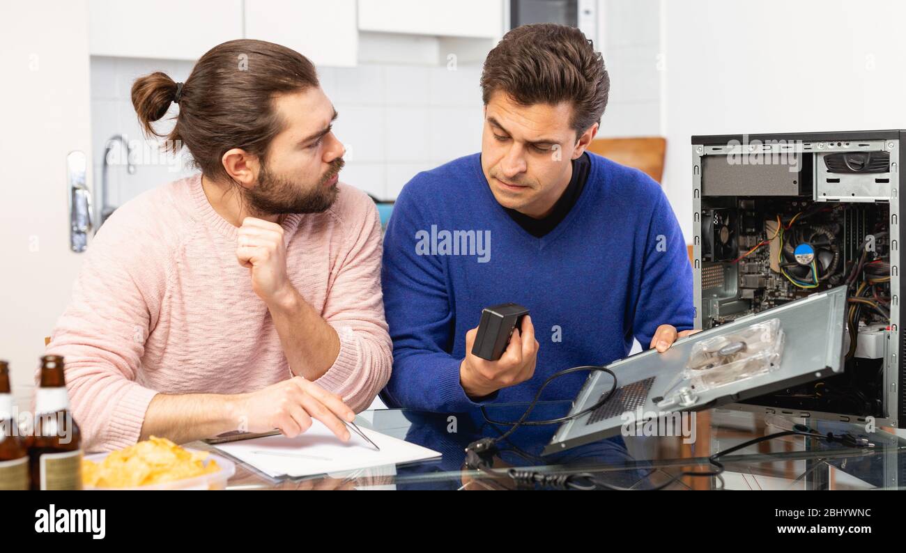 Men drink beer and repair the desktop computer Stock Photo - Alamy