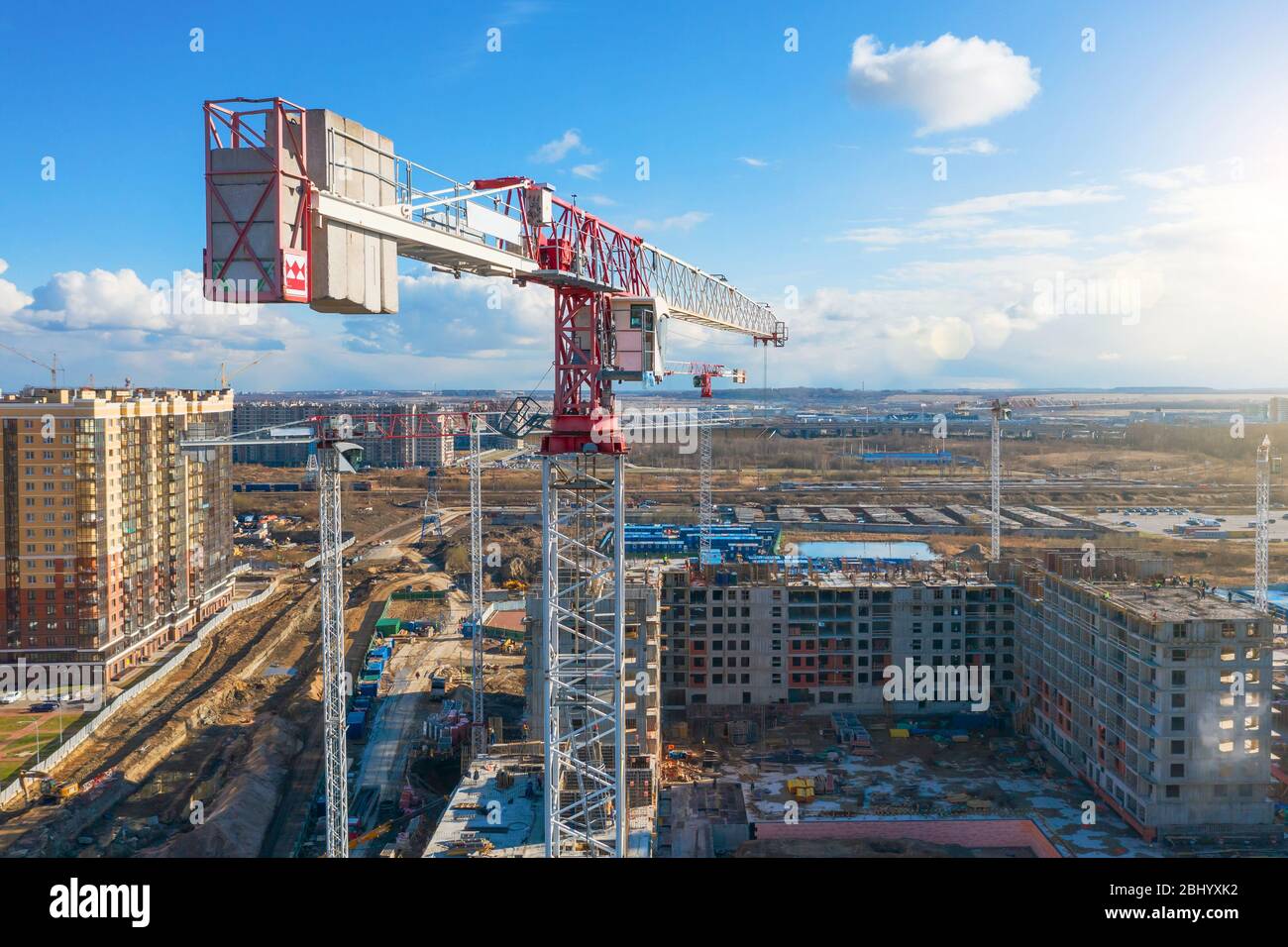 Construction cranes erected a multi-storey building with apartments on ...