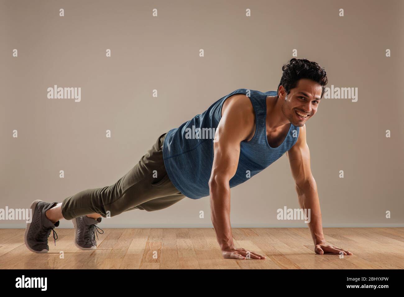Man doing pushups over a plain background Stock Photo - Alamy