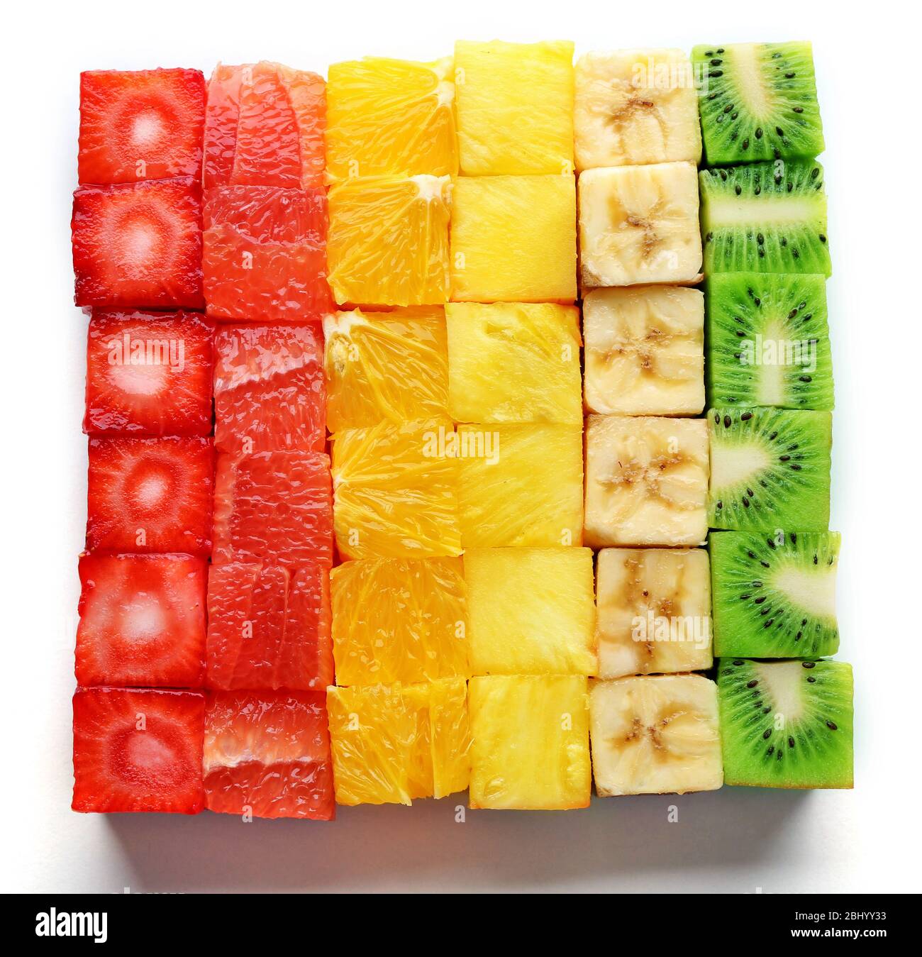 Colorful fresh sliced fruit cubes isolated on white Stock Photo - Alamy