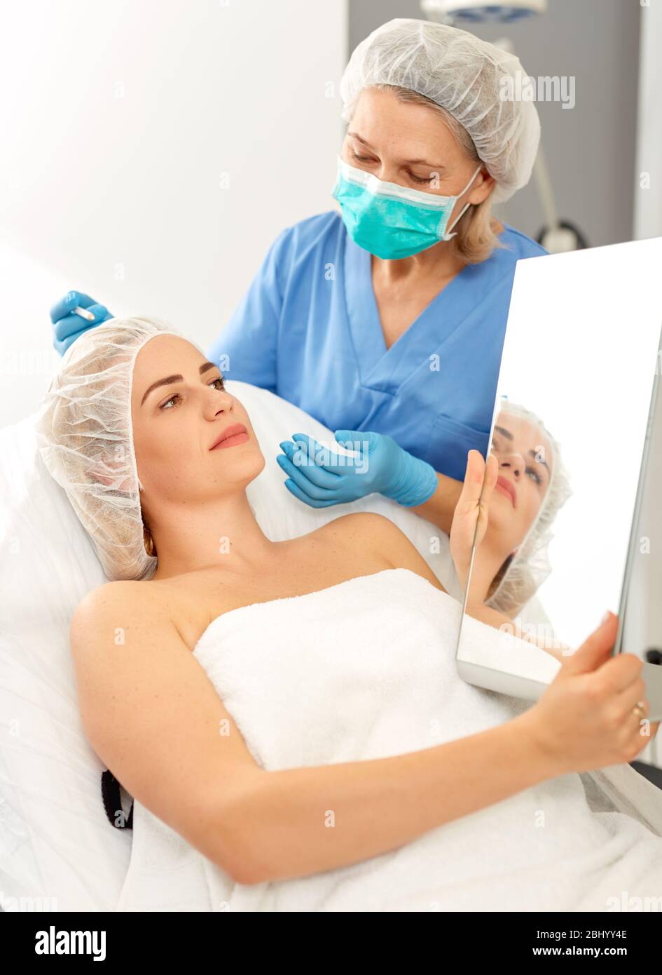 Plastic surgeon preparing for operation on woman face Stock Photo - Alamy