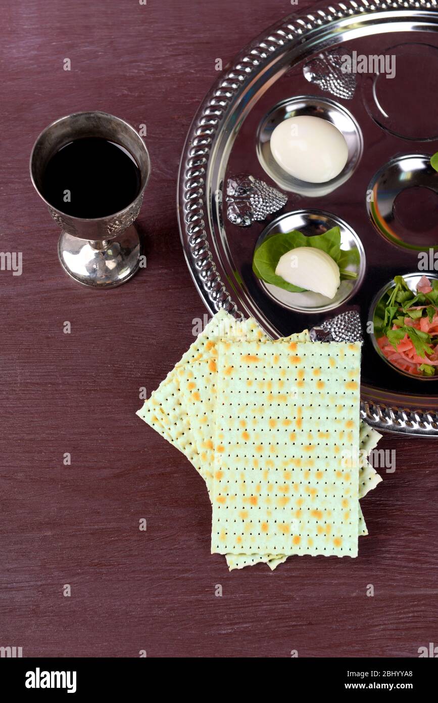 Matzo for Passover with Seder meal with wine on plate on table close up ...