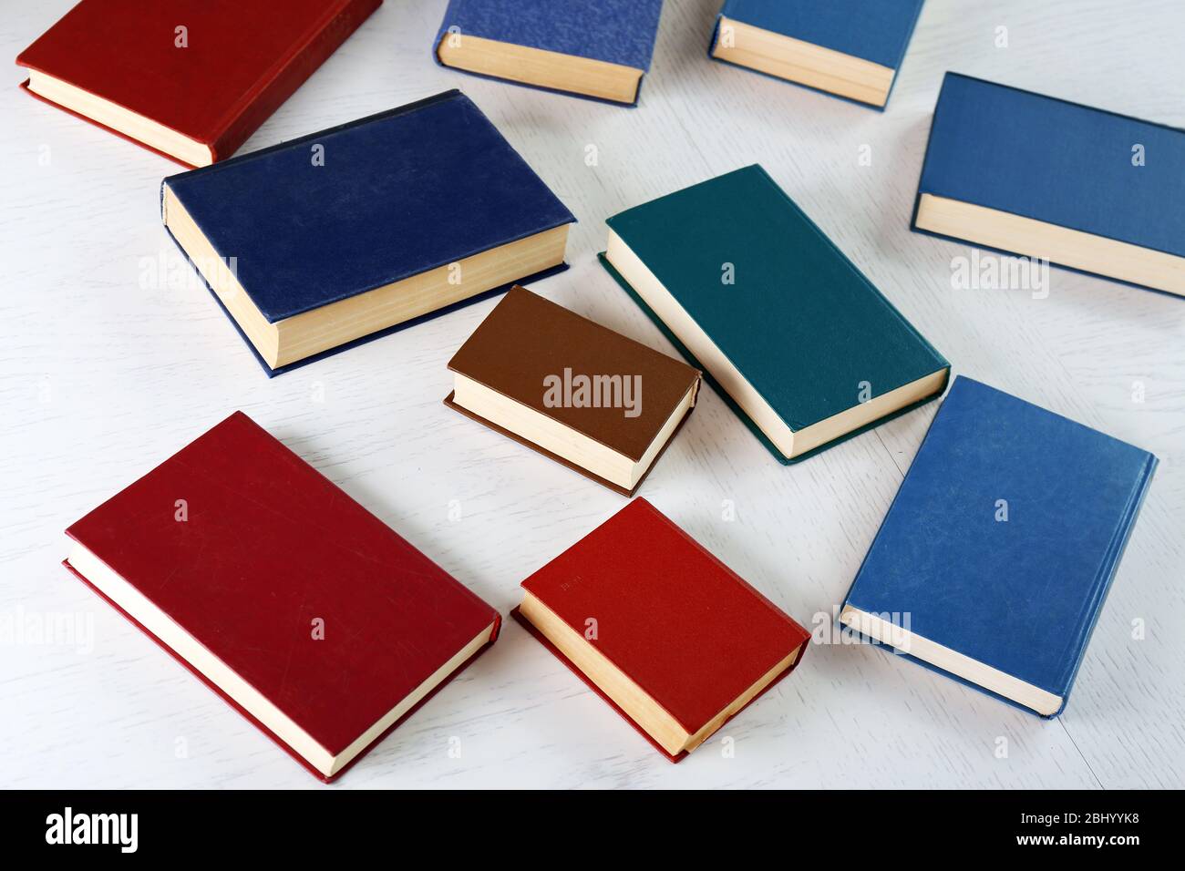 Books on light background Stock Photo - Alamy