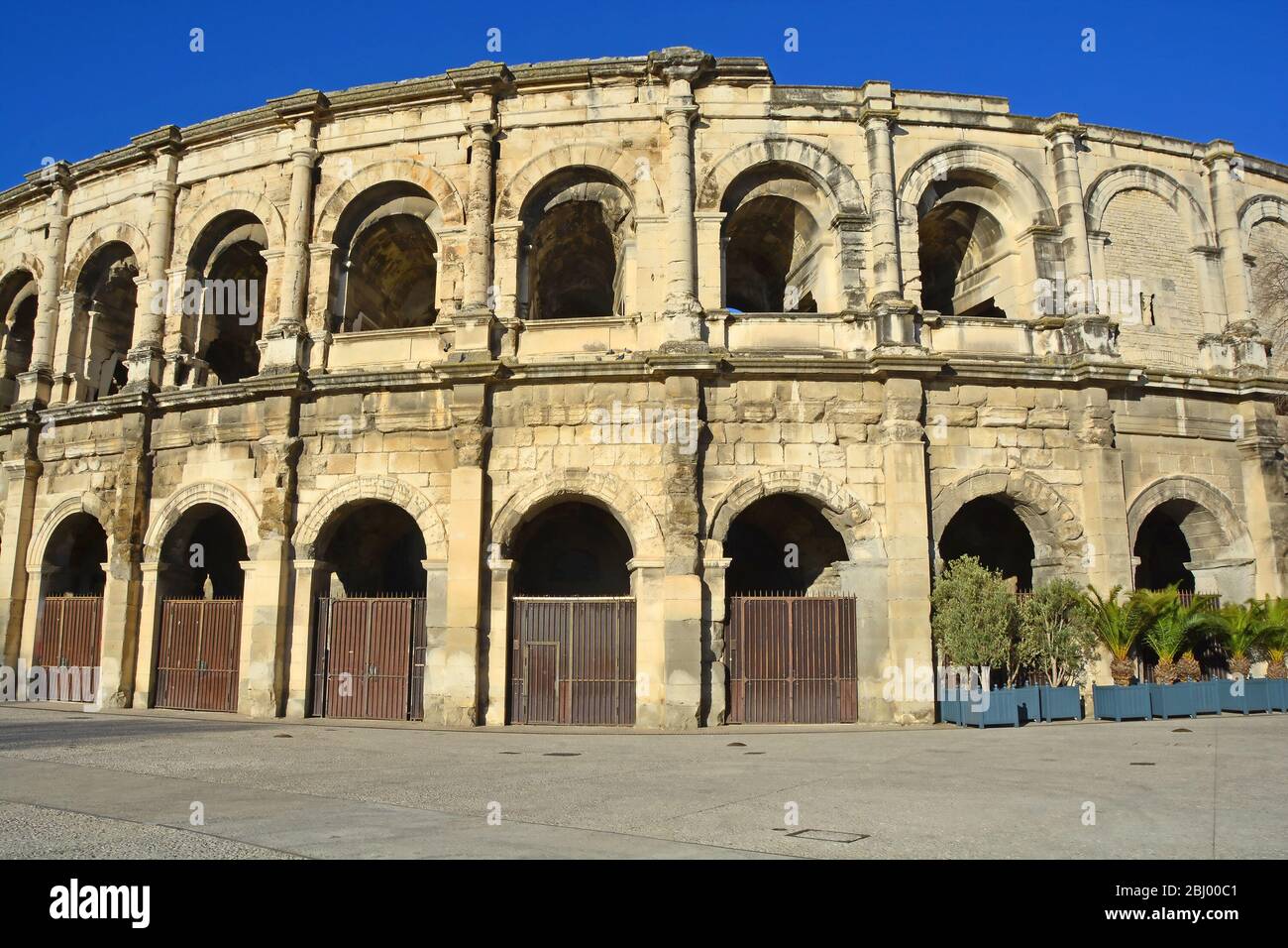 The outer wall of the Ancient Roman Amphitheatre at Nimes in the South ...