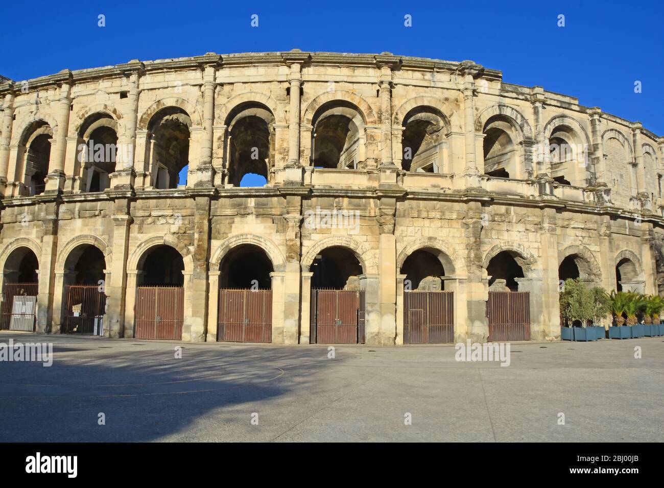The outer wall of the Ancient Roman Amphitheatre at Nimes in the South ...