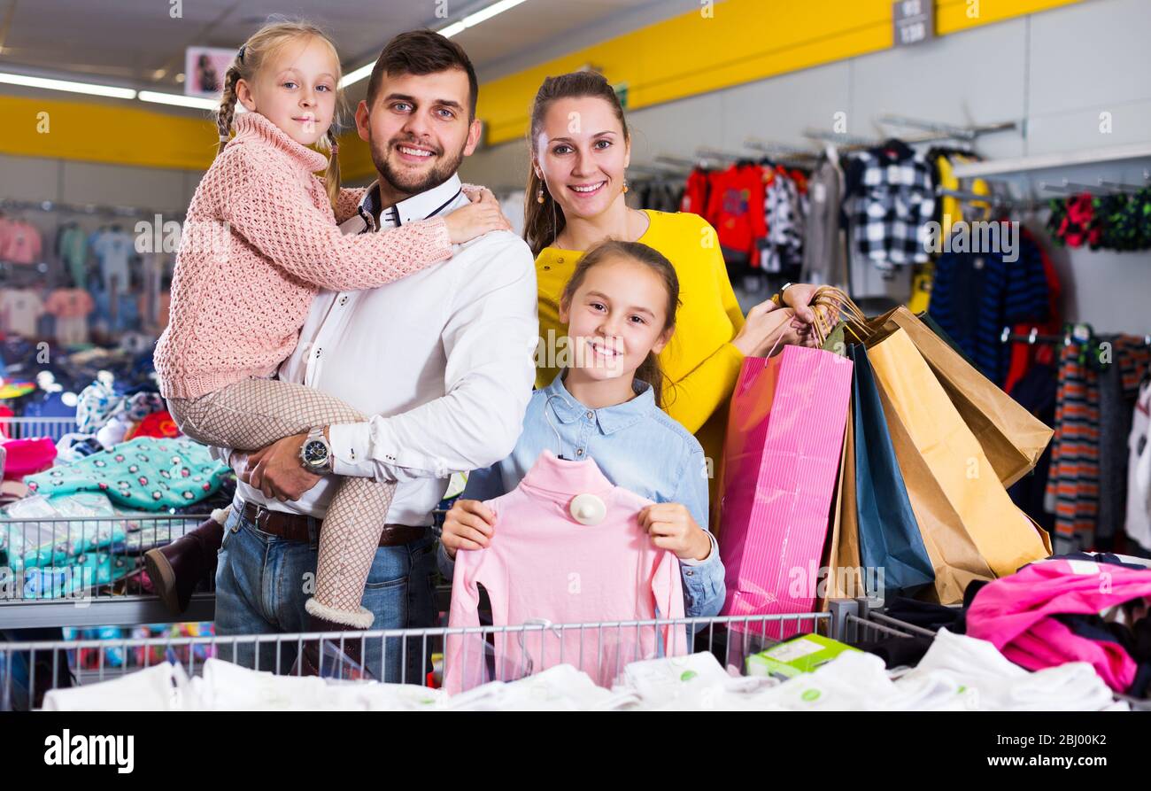 smiling parents with two little girls during family shopping Stock ...