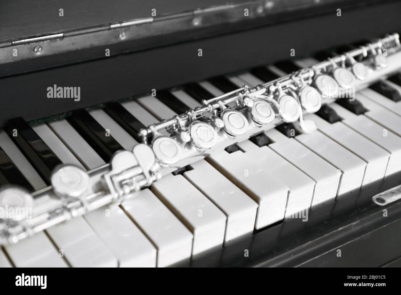 Flute on piano keys, closeup Stock Photo - Alamy