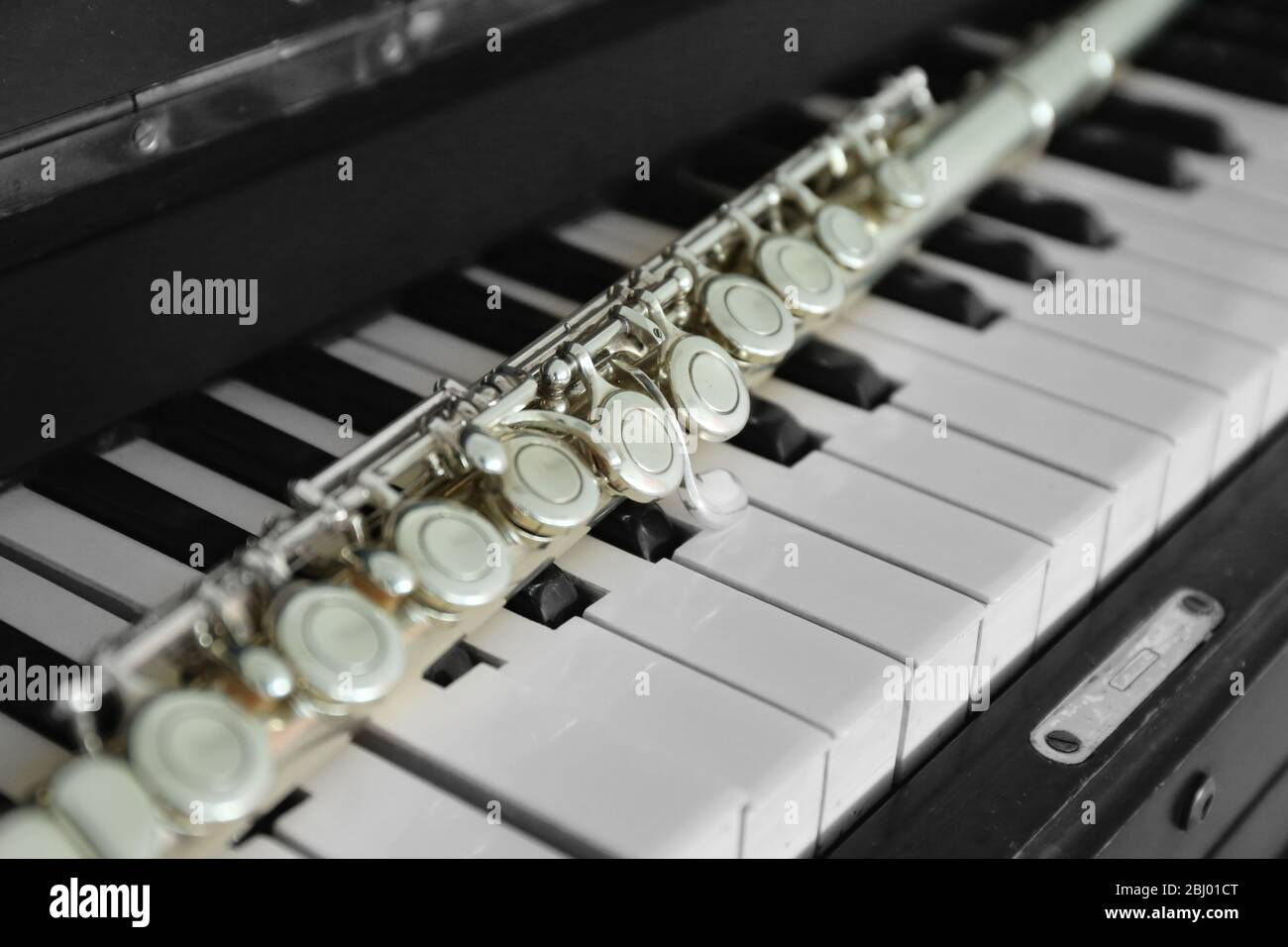 Flute on piano keys, closeup Stock Photo - Alamy