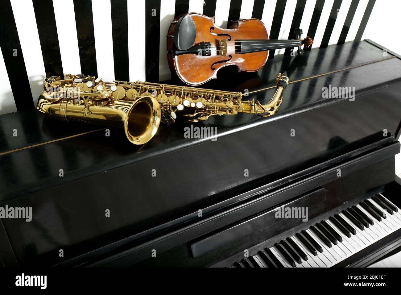 Violin and saxophone on piano background Stock Photo - Alamy