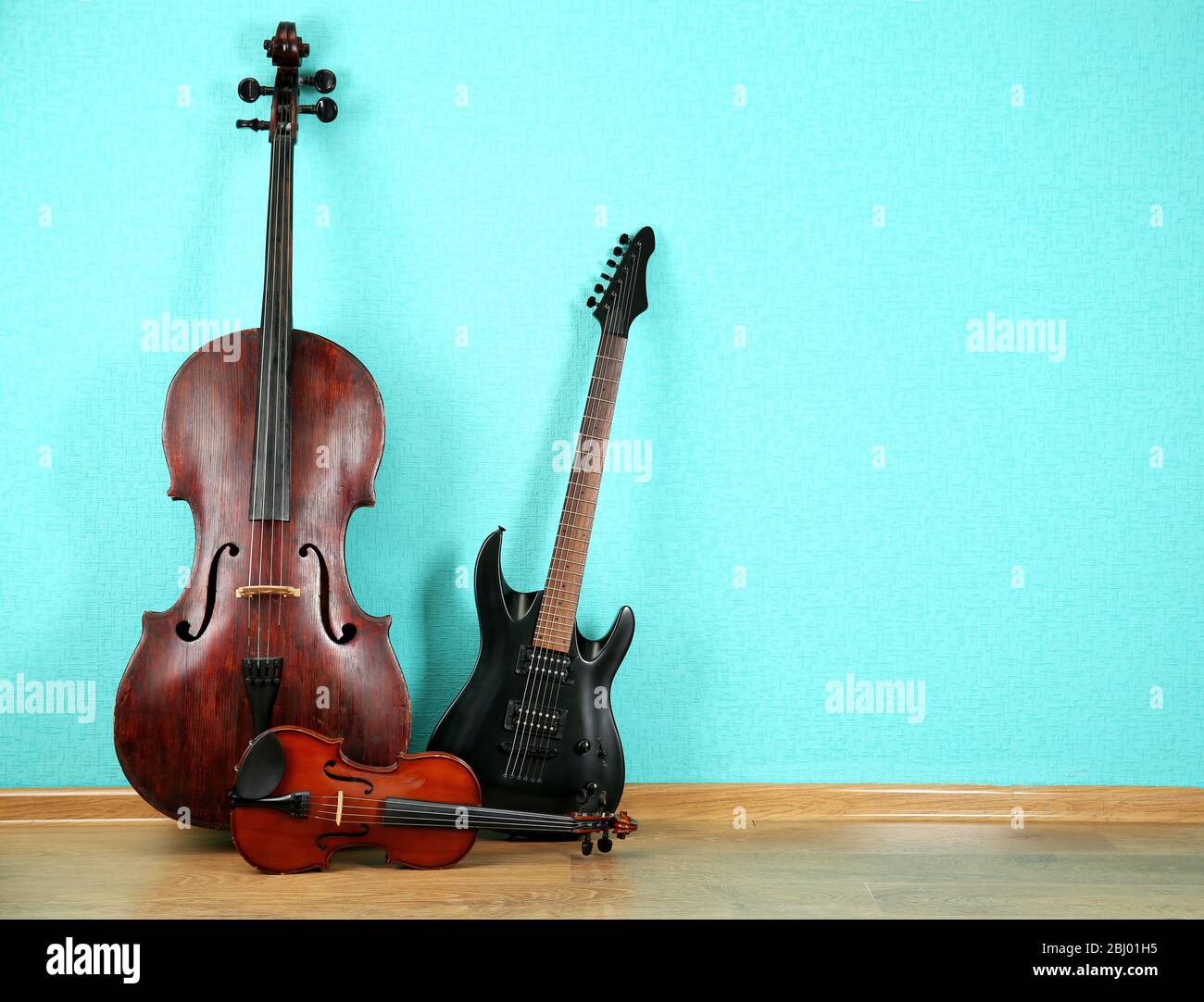 Musical instruments on turquoise wallpaper background Stock Photo - Alamy