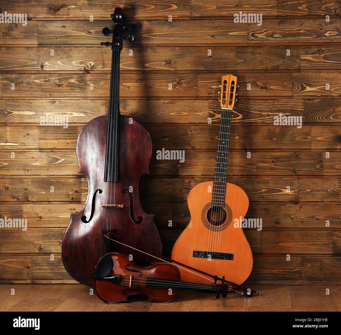 Musical instruments on wooden planks background Stock Photo - Alamy