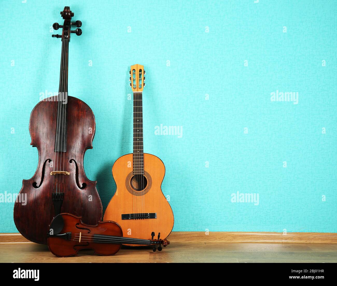 Musical instruments on turquoise wallpaper background Stock Photo - Alamy