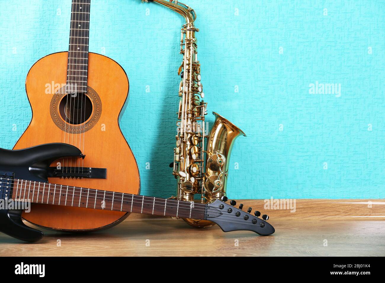 Musical instruments on turquoise wallpaper background Stock Photo - Alamy
