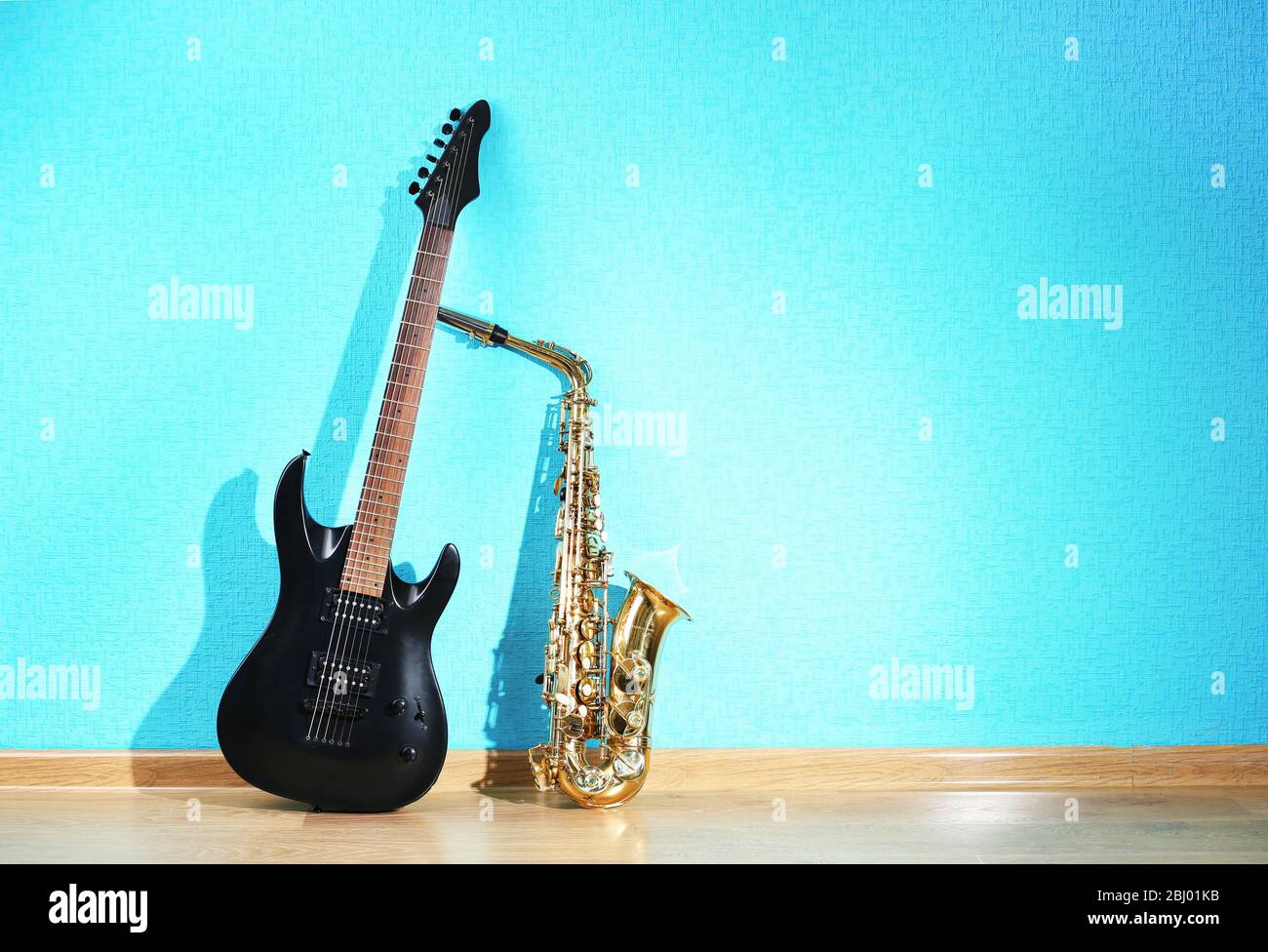 Musical instruments on turquoise wallpaper background Stock Photo - Alamy